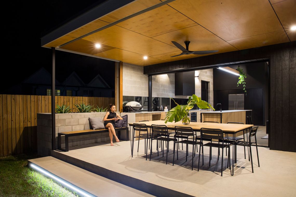 Covered Outdoor Dining Spills Onto a Courtyard in This Tropical Home