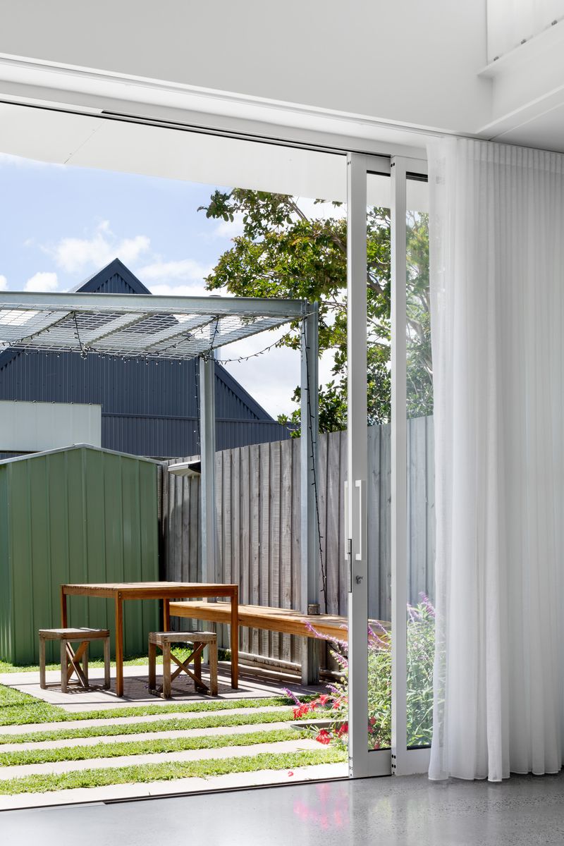 This addition feels spacious in spite of a long, narrow block...