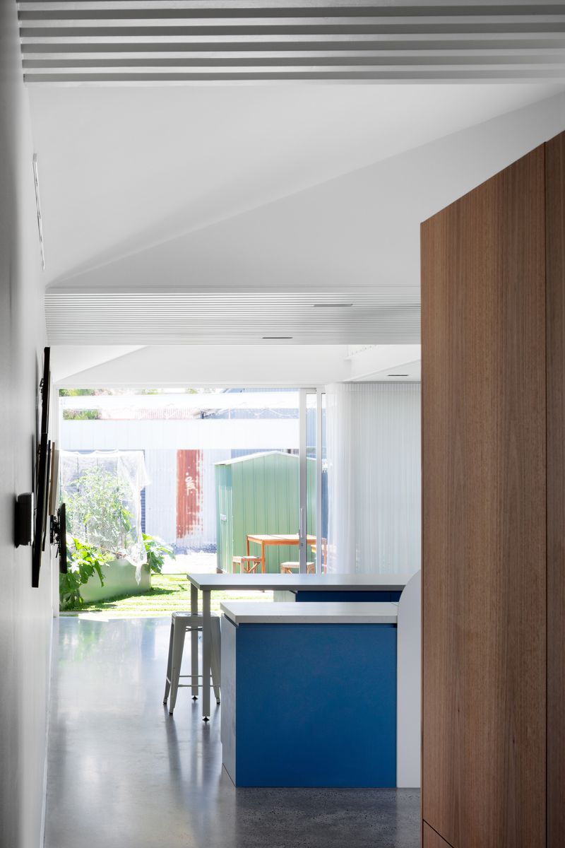 This addition feels spacious in spite of a long, narrow block...