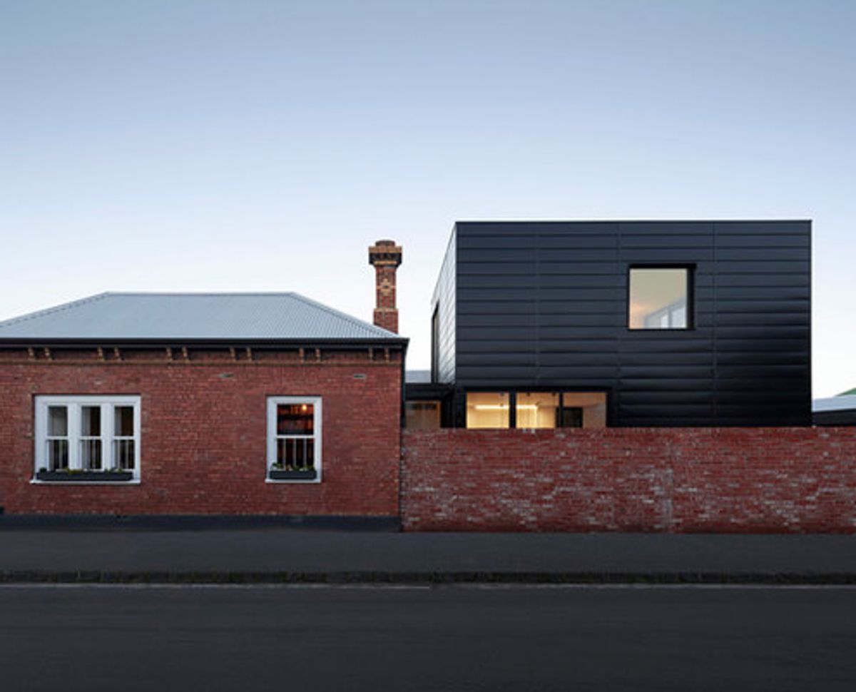 A Black Modular Home Peeks Over the Fence in This Brunswick Backyard