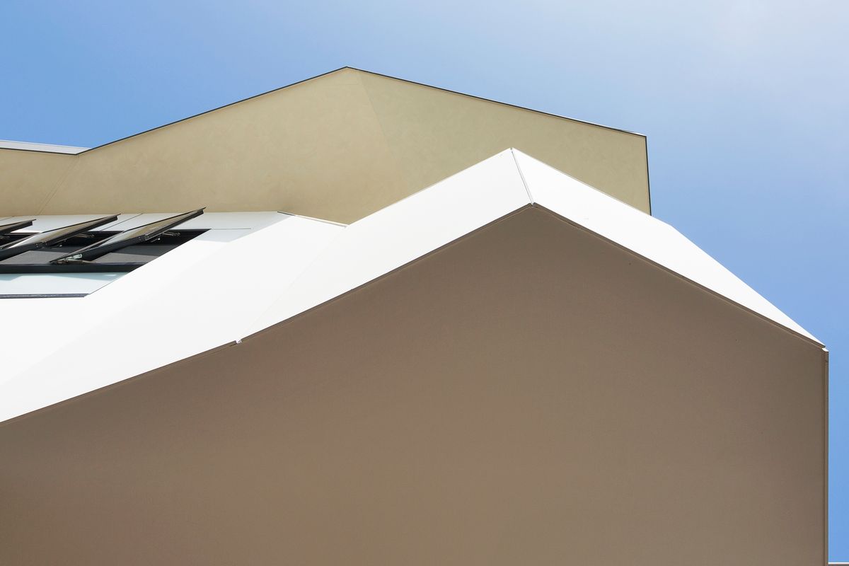 Roofline of New Addition Extends Off Original Like a Fluttering Flag