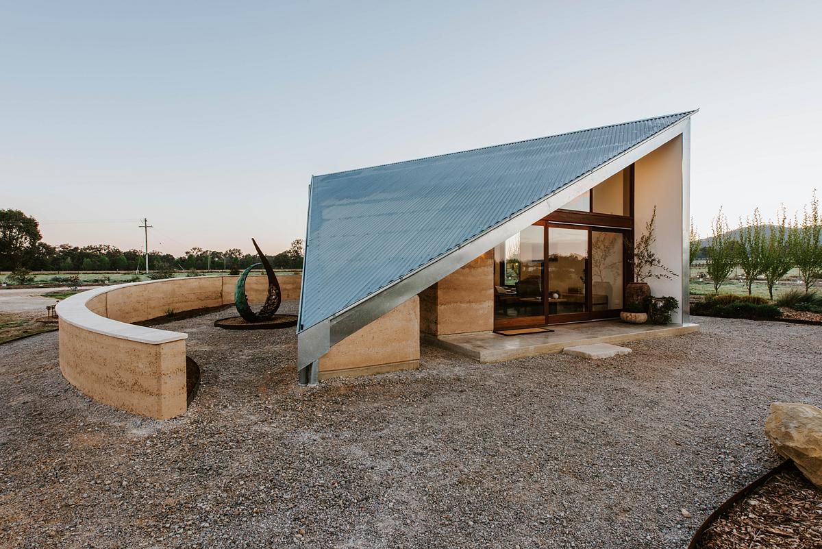 Sculptural Roofs and Rammed Earth Walls Define this Bold Design