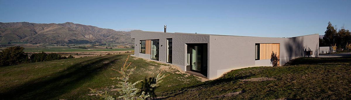 Lake Hawea Courtyard House Bunkers Against a Stunningly Rugged Landscape