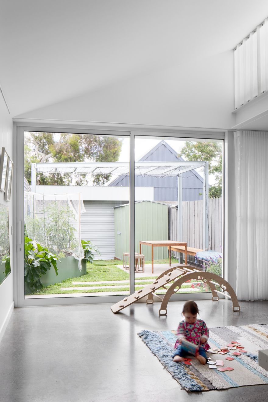 This addition feels spacious in spite of a long, narrow block...