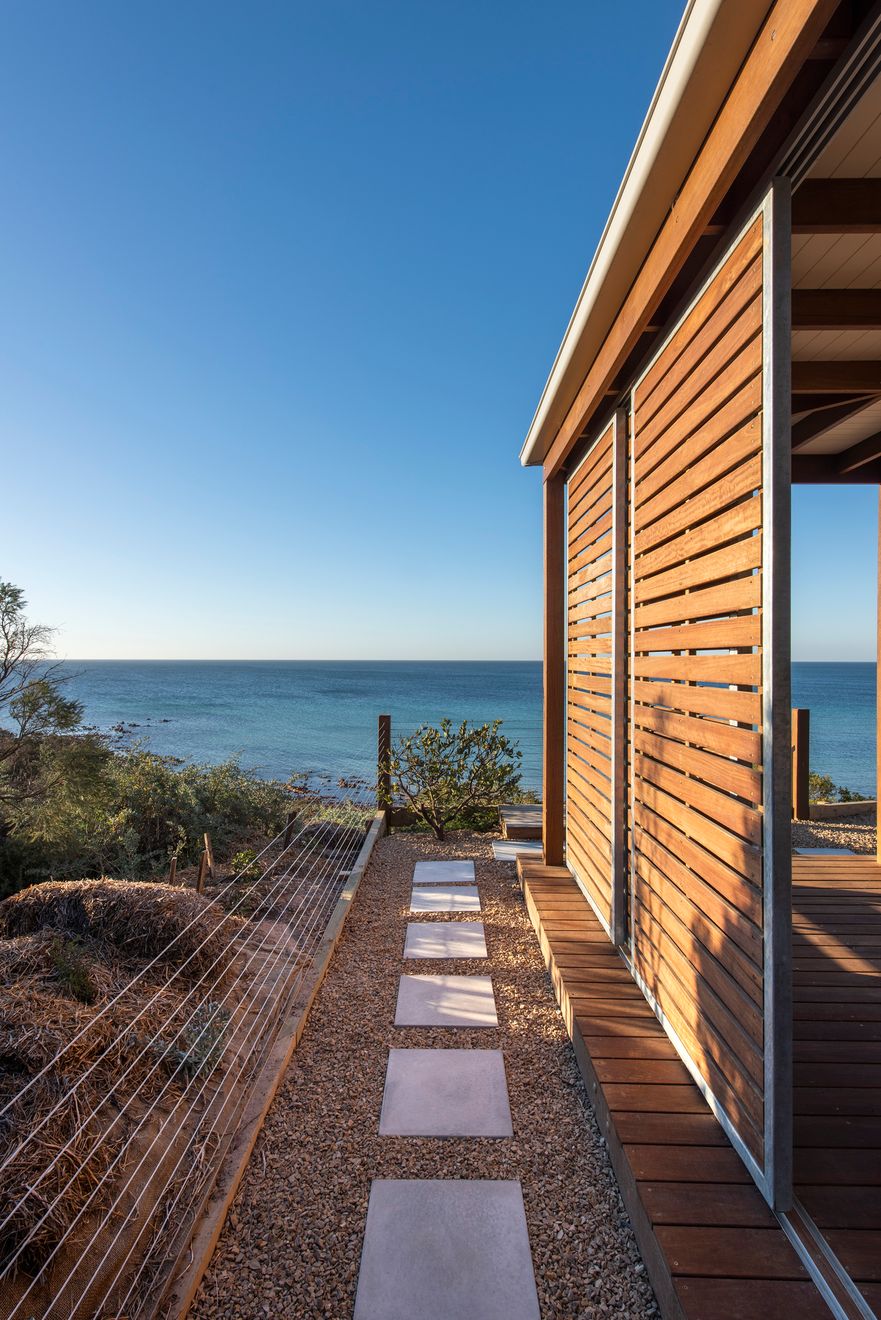 Beach House Nestles Into Its Spectacular Limestone Cliff Setting