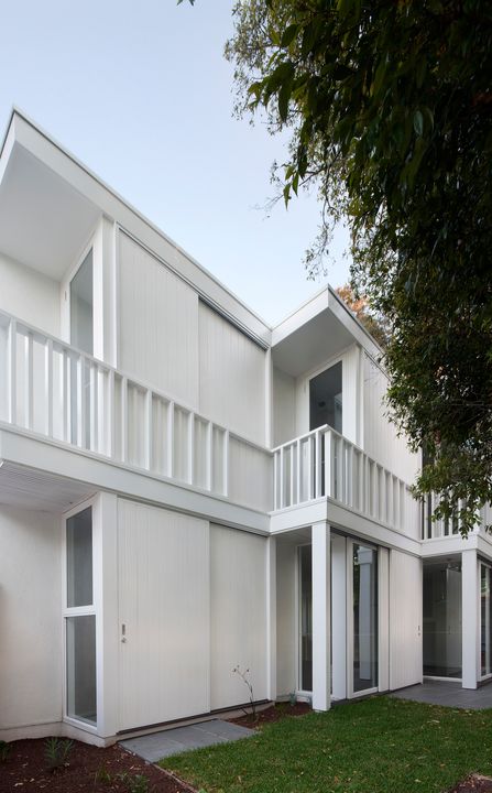 Folded Facades Give Two Identical Homes Their Own Identity