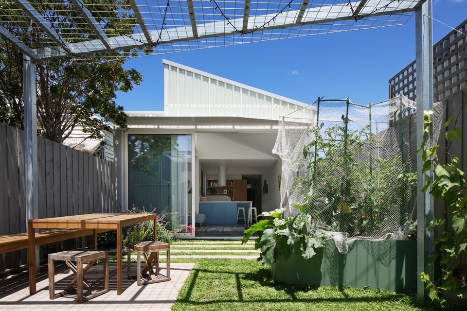 This addition feels spacious in spite of a long, narrow block...